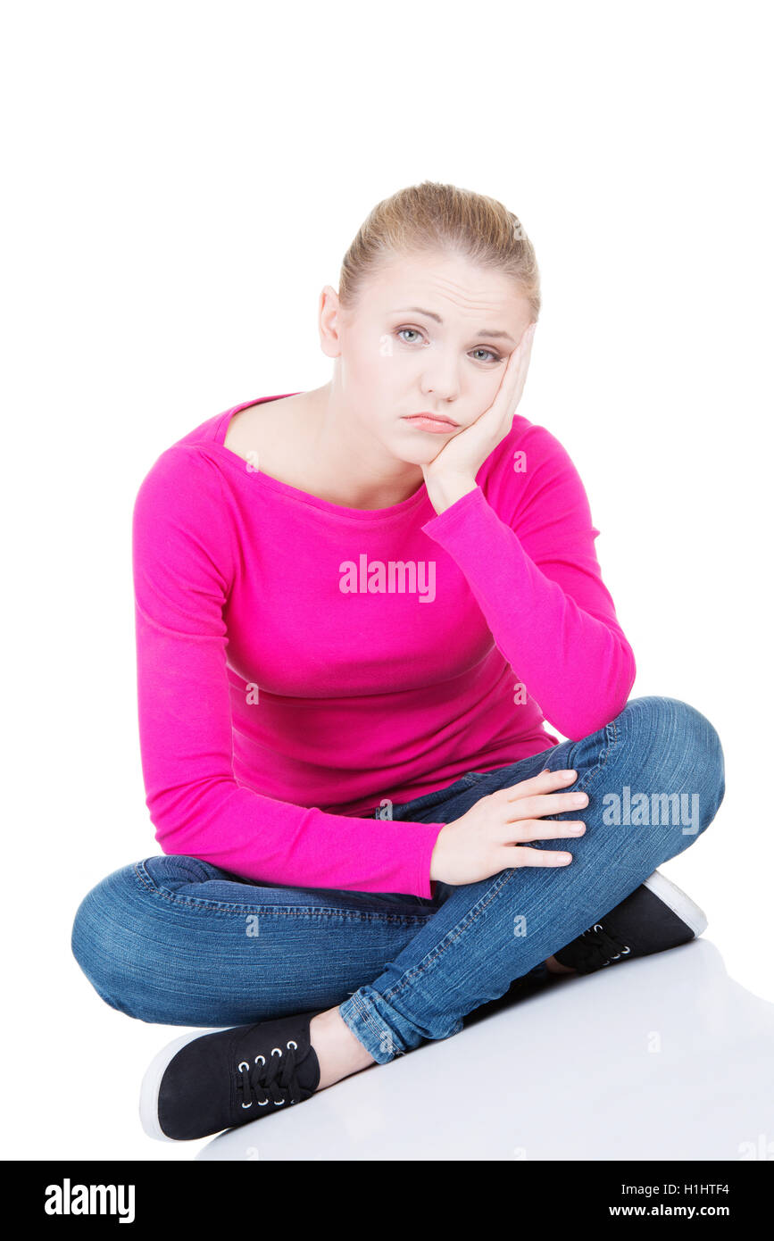 Young sad woman sitting Stock Photo - Alamy