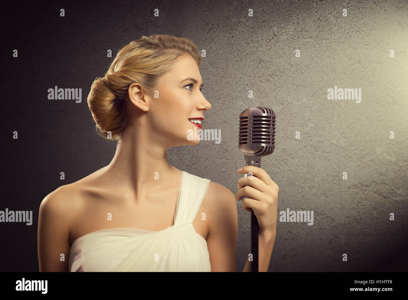 attractive female singer with microphone Stock Photo - Alamy