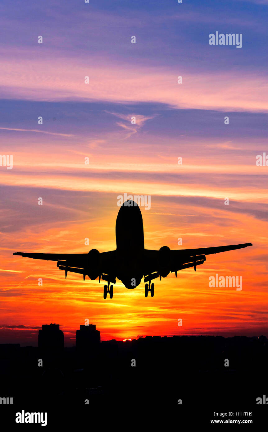 Plane and sunset Stock Photo - Alamy