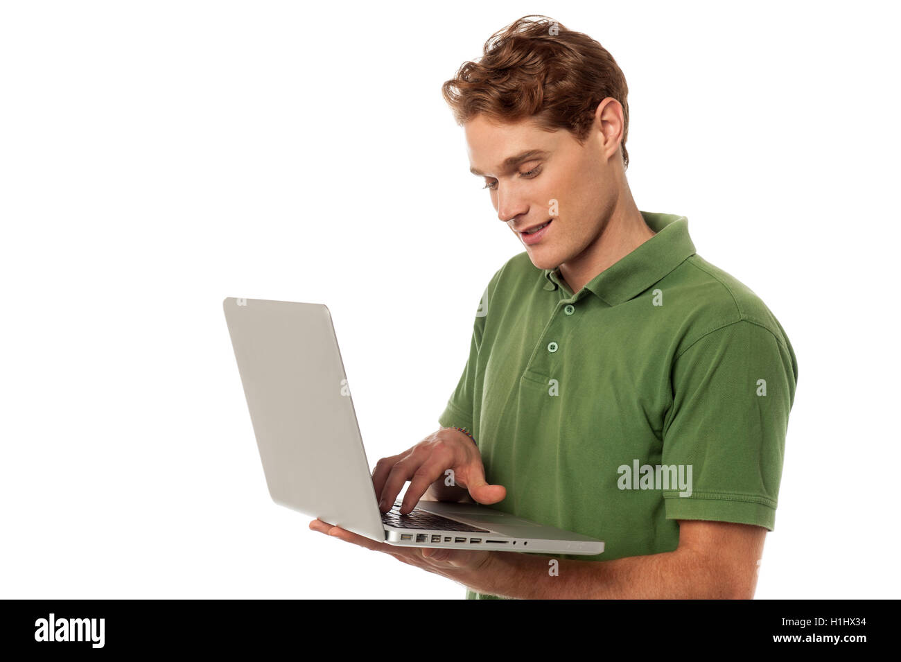 Handsome guy operating laptop Stock Photo - Alamy