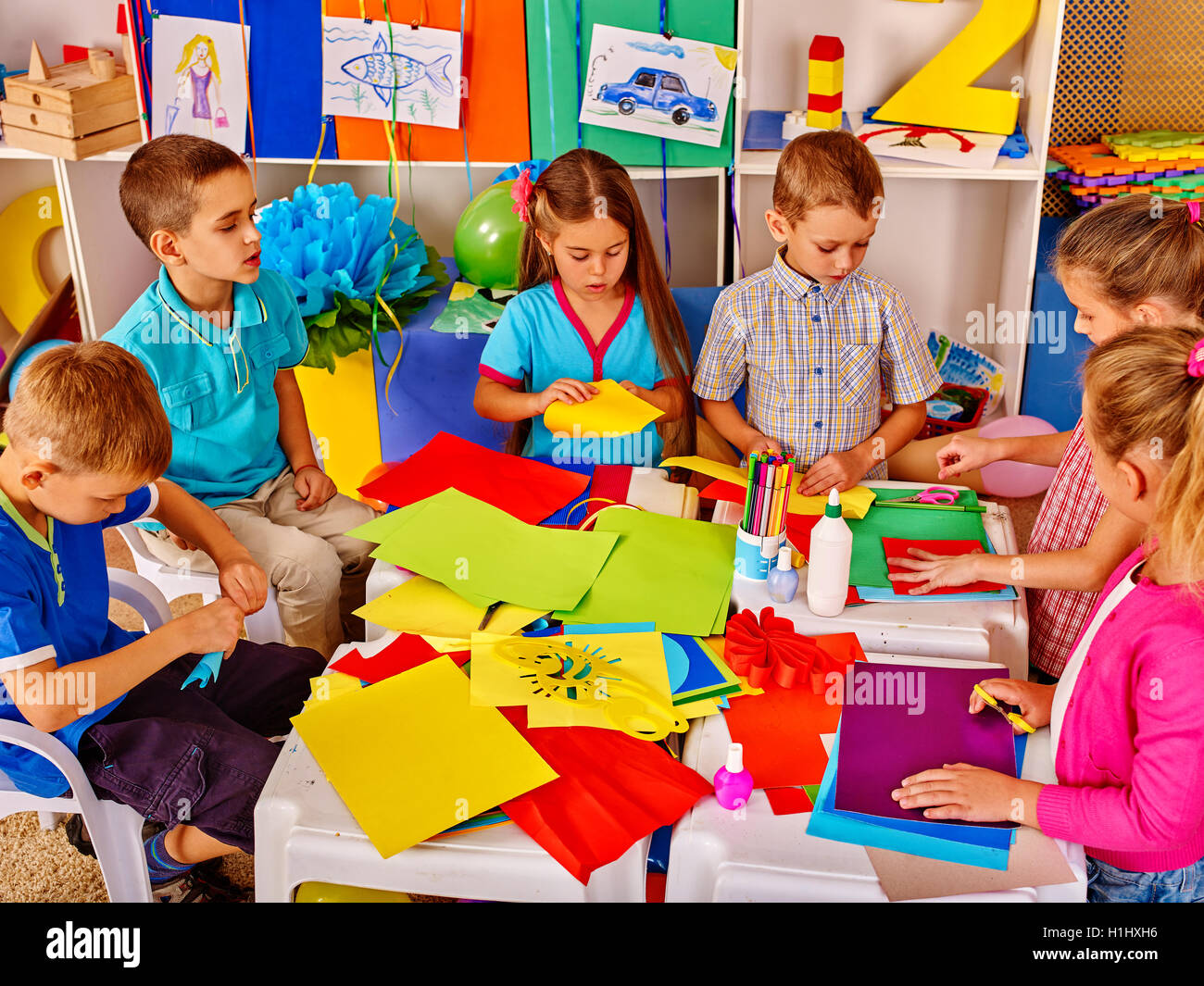 Children school are making something out of colored paper Stock Photo ...