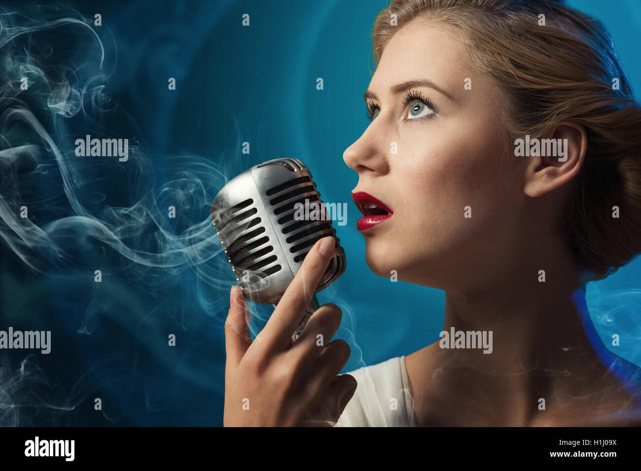 attractive female singer with microphone Stock Photo - Alamy