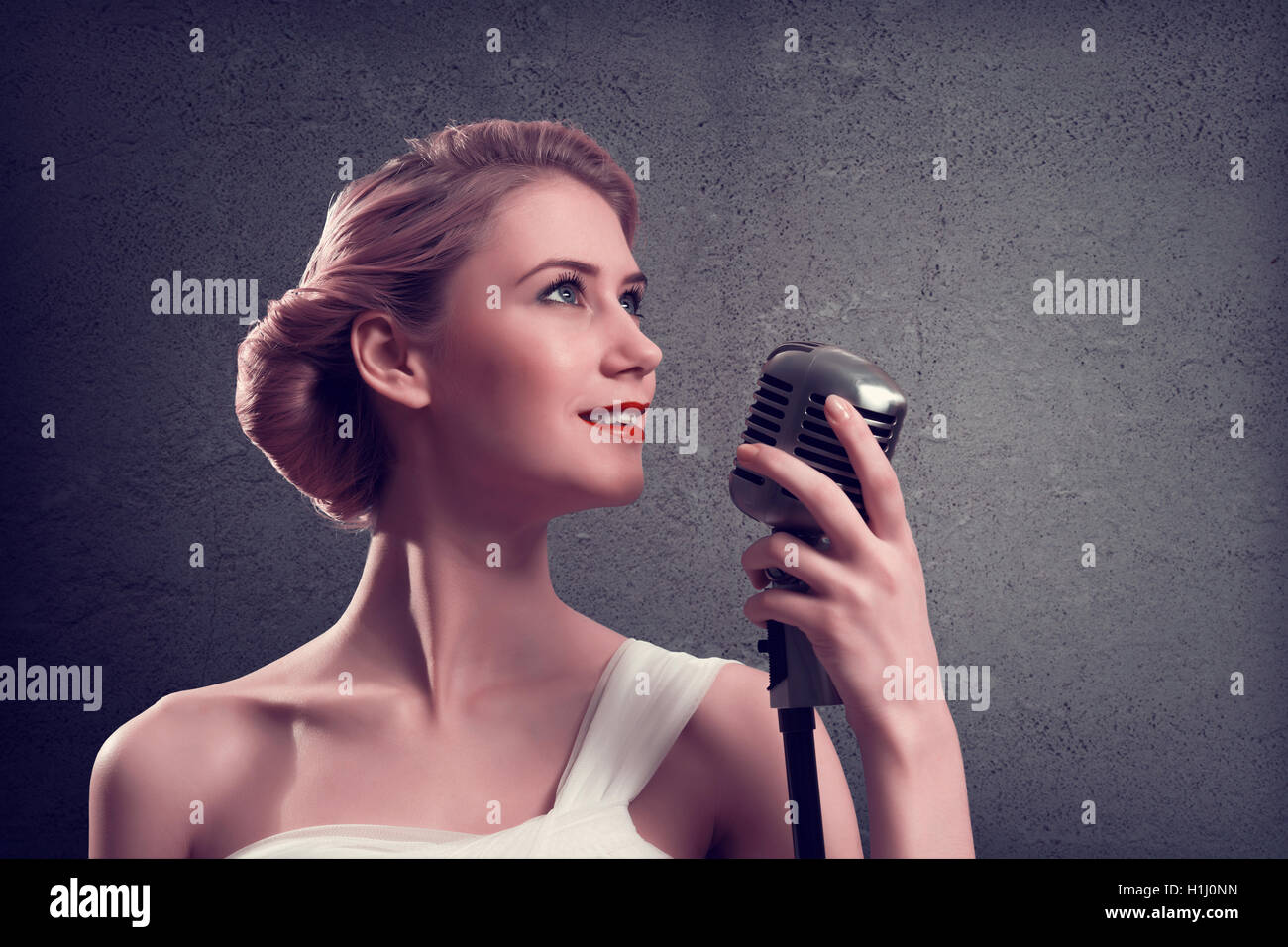 attractive female singer with microphone Stock Photo - Alamy