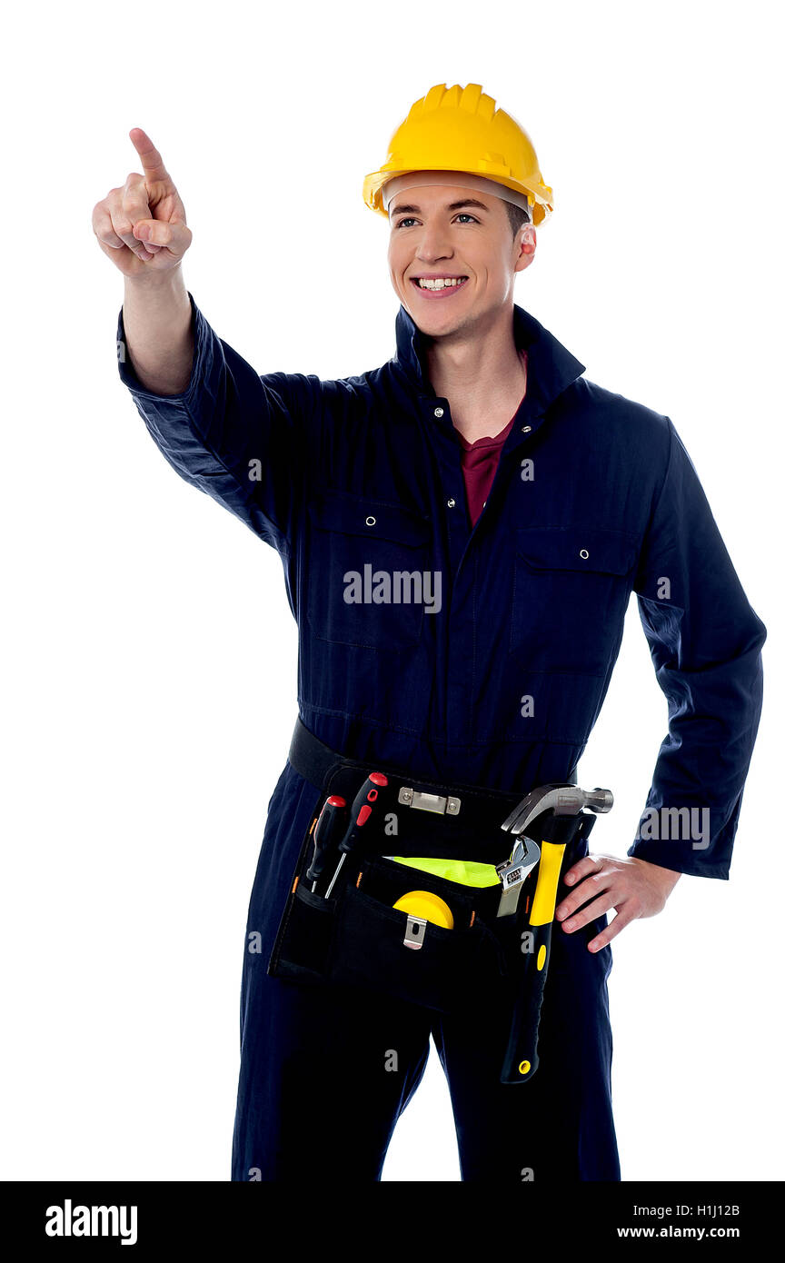 Construction worker pointing and looking away Stock Photo - Alamy
