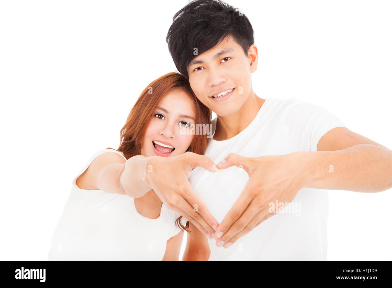 Young couple making heart shape by hands Stock Photo - Alamy