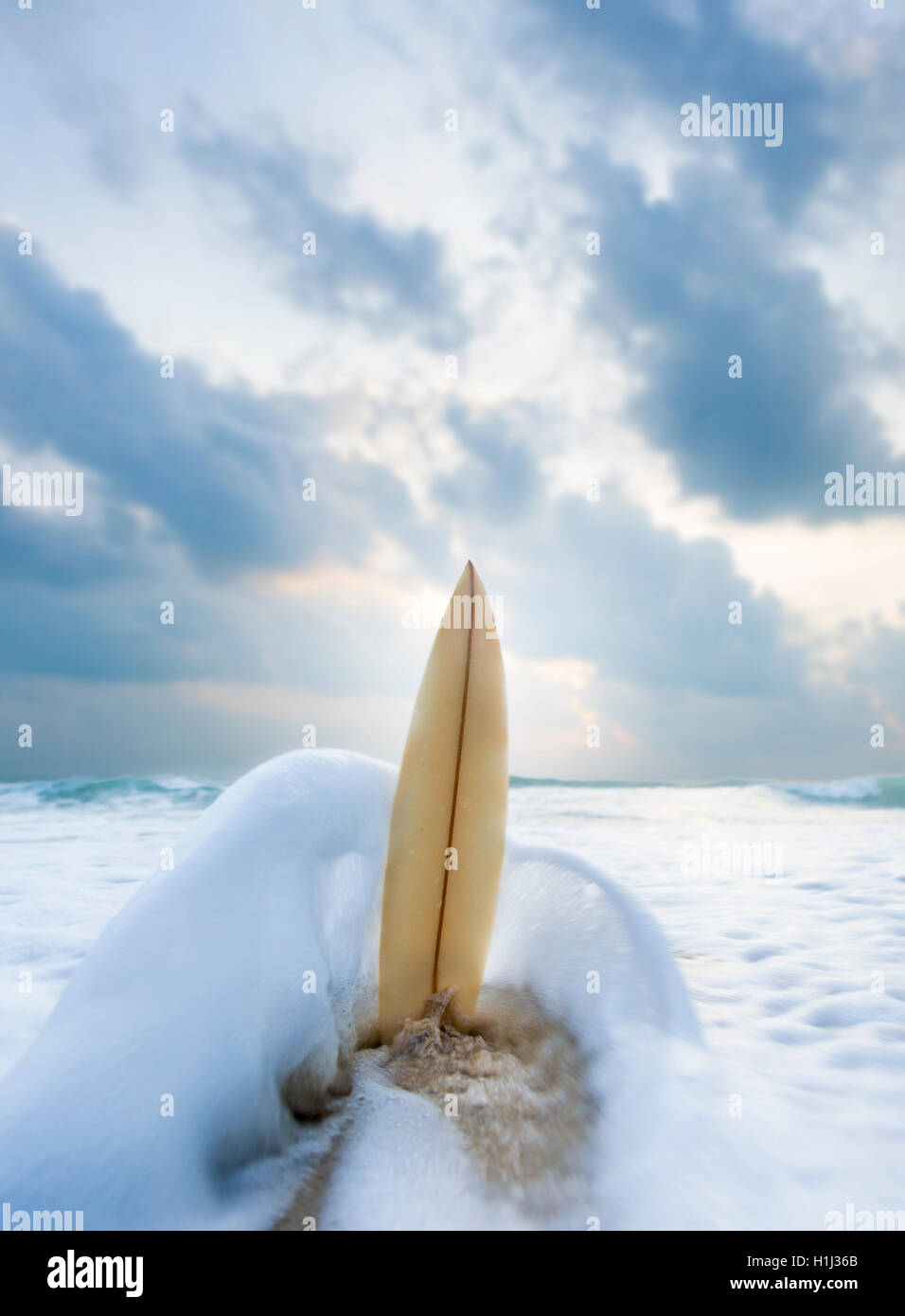 Surfboard on the beach at sunset Stock Photo - Alamy