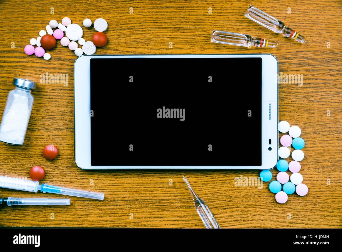 Tablet pc with medical objects on a desk Stock Photo - Alamy