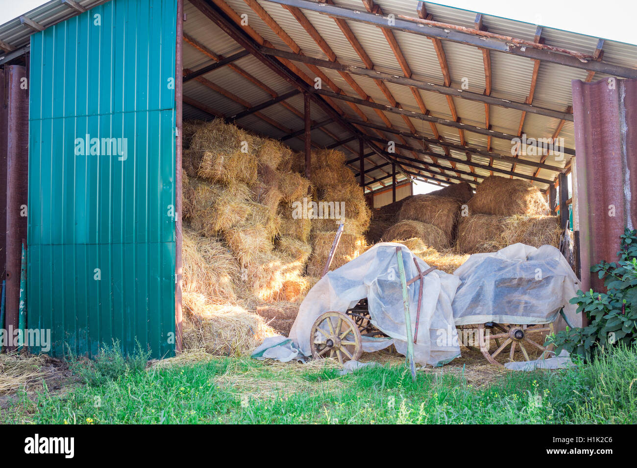Hay stacks and bales at farm haylof hangar storage Stock Photo - Alamy