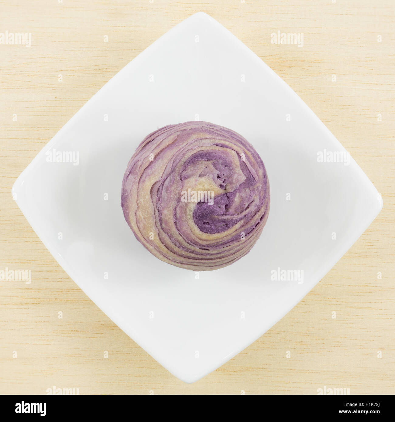 The Taiwanese violet crystal taro cake on the small white square dish ...