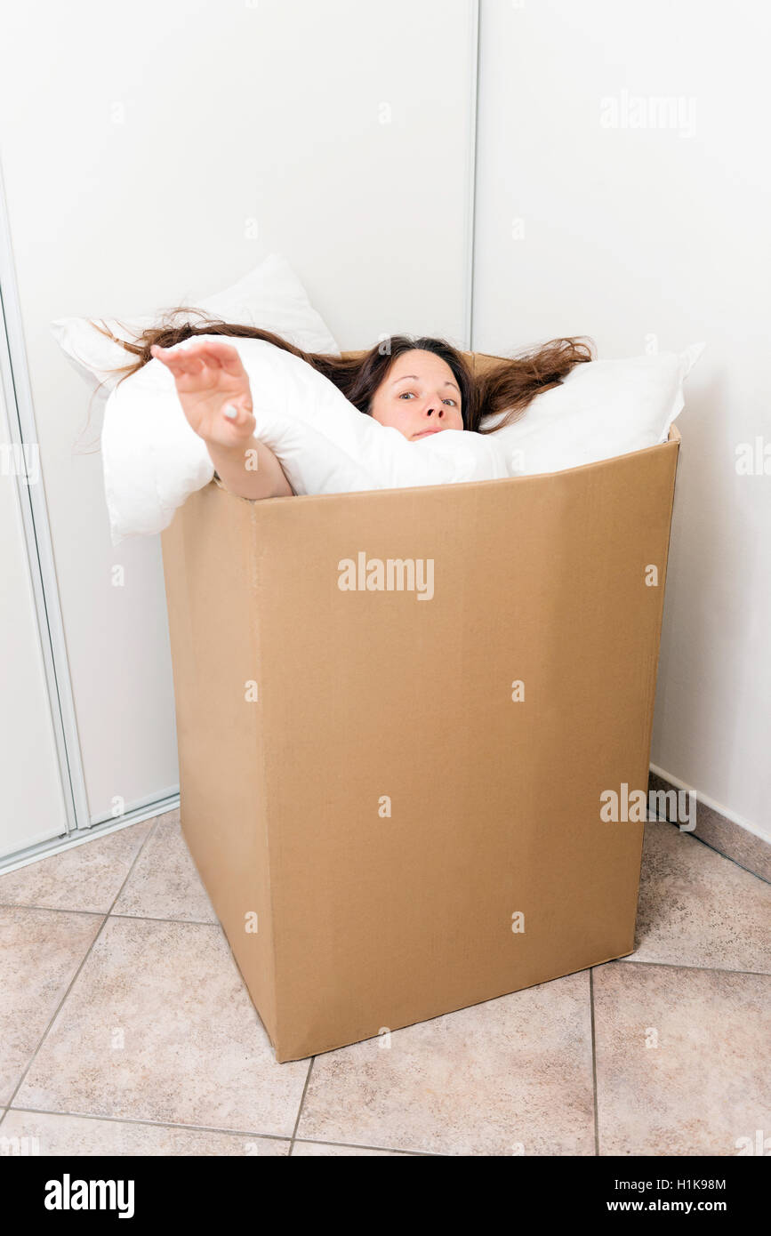 Young woman drowning in a box Stock Photo - Alamy