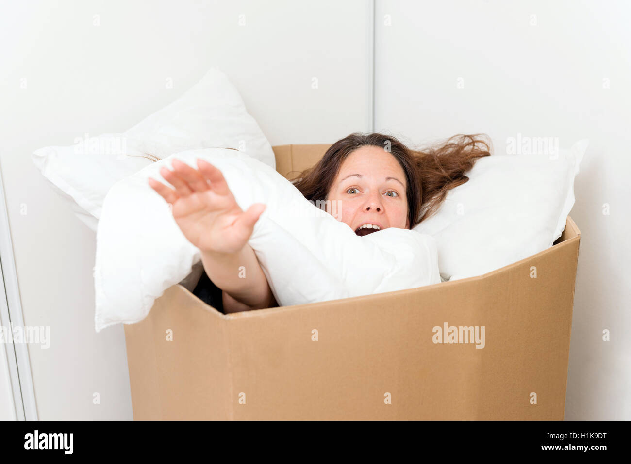 Young woman drowning in a box Stock Photo - Alamy