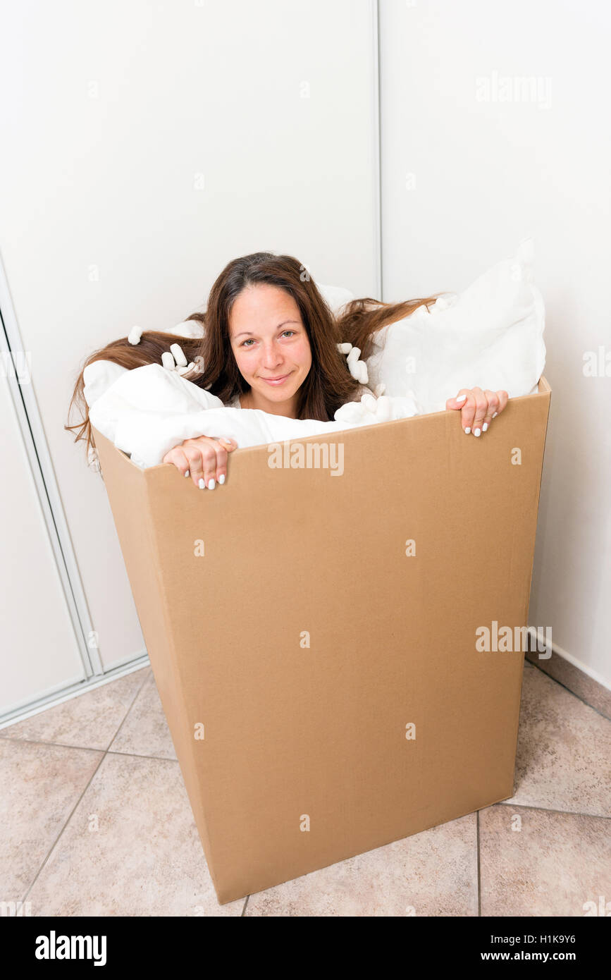 Young woman in a box with packing material Stock Photo - Alamy