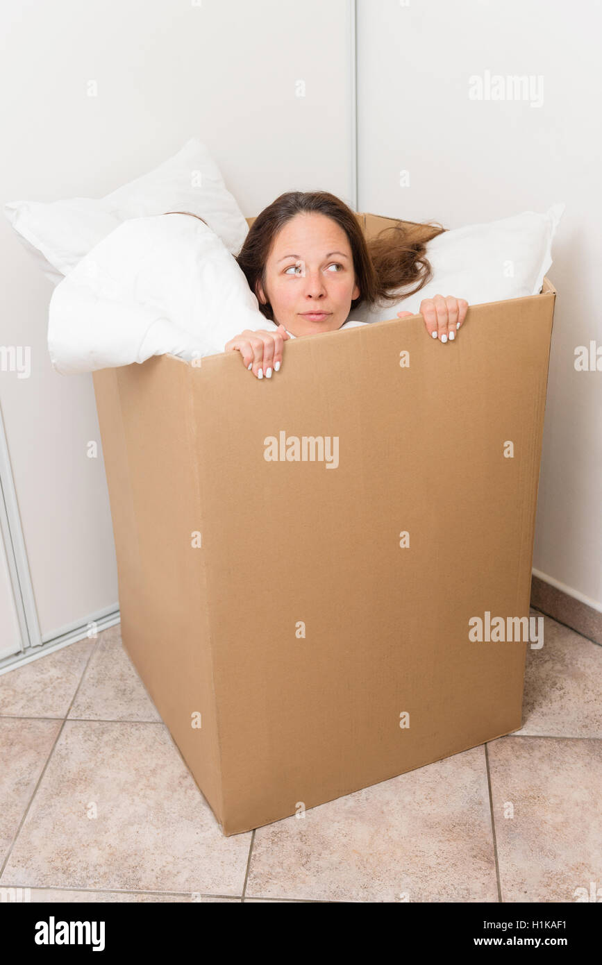 Young woman looking out of the box Stock Photo - Alamy