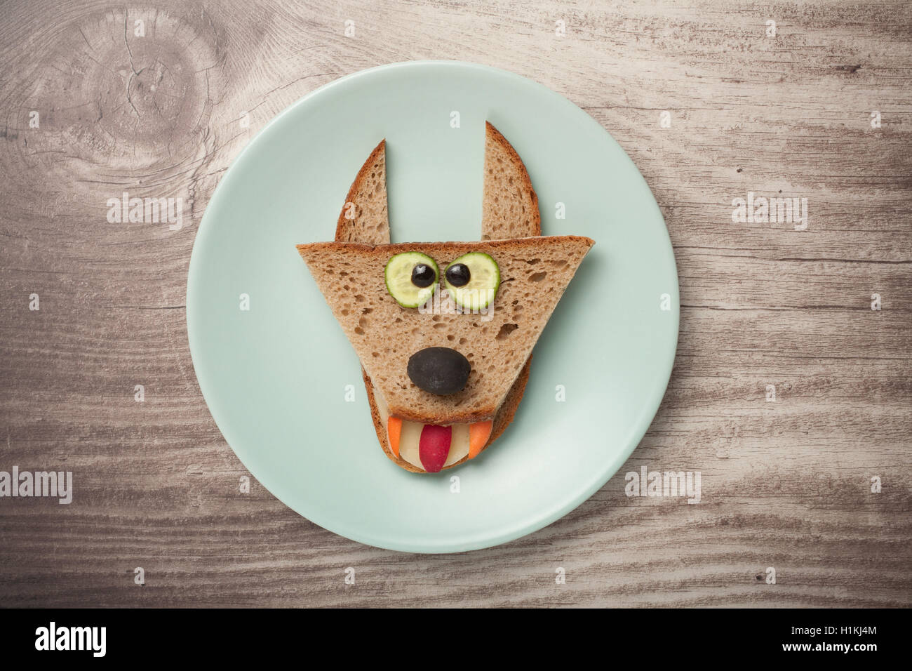Happy wolf made of bread on wood and plate Stock Photo - Alamy