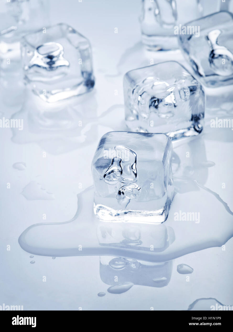 Melted pieces of ice on a white background Stock Photo - Alamy