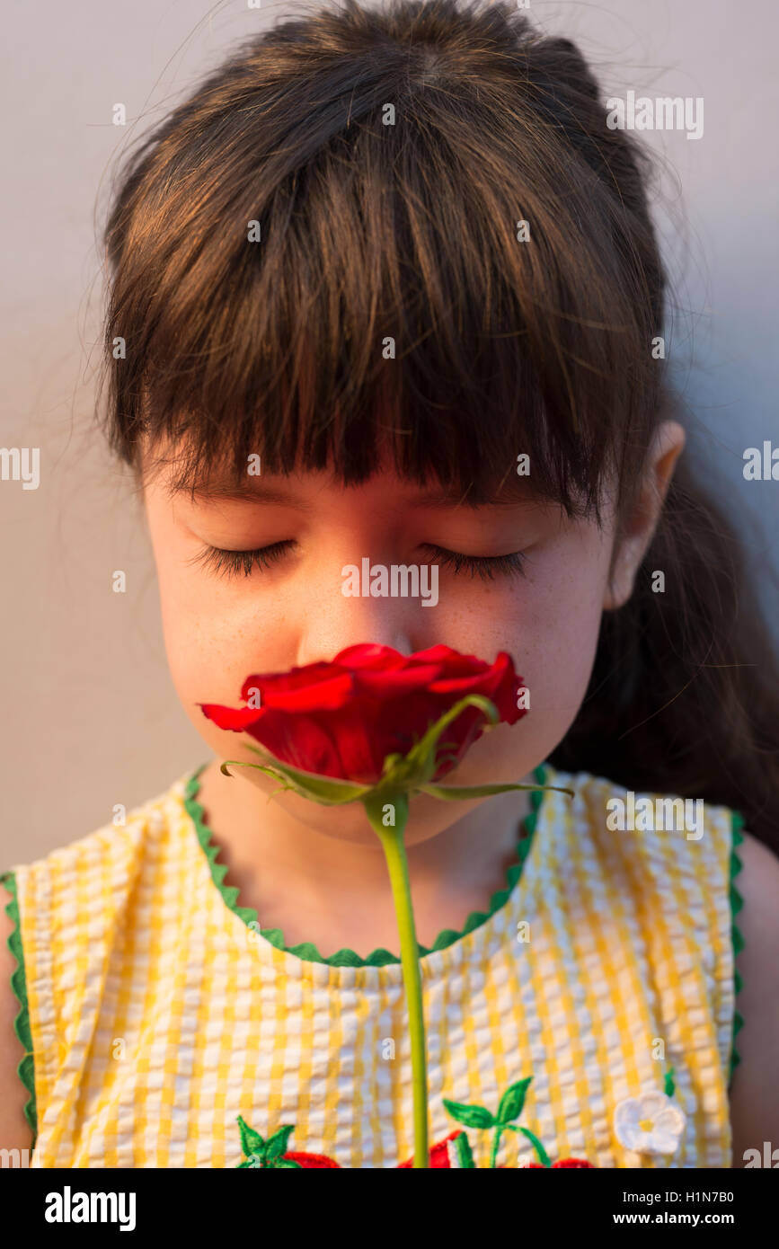 Child smelling rose hi-res stock photography and images - Alamy