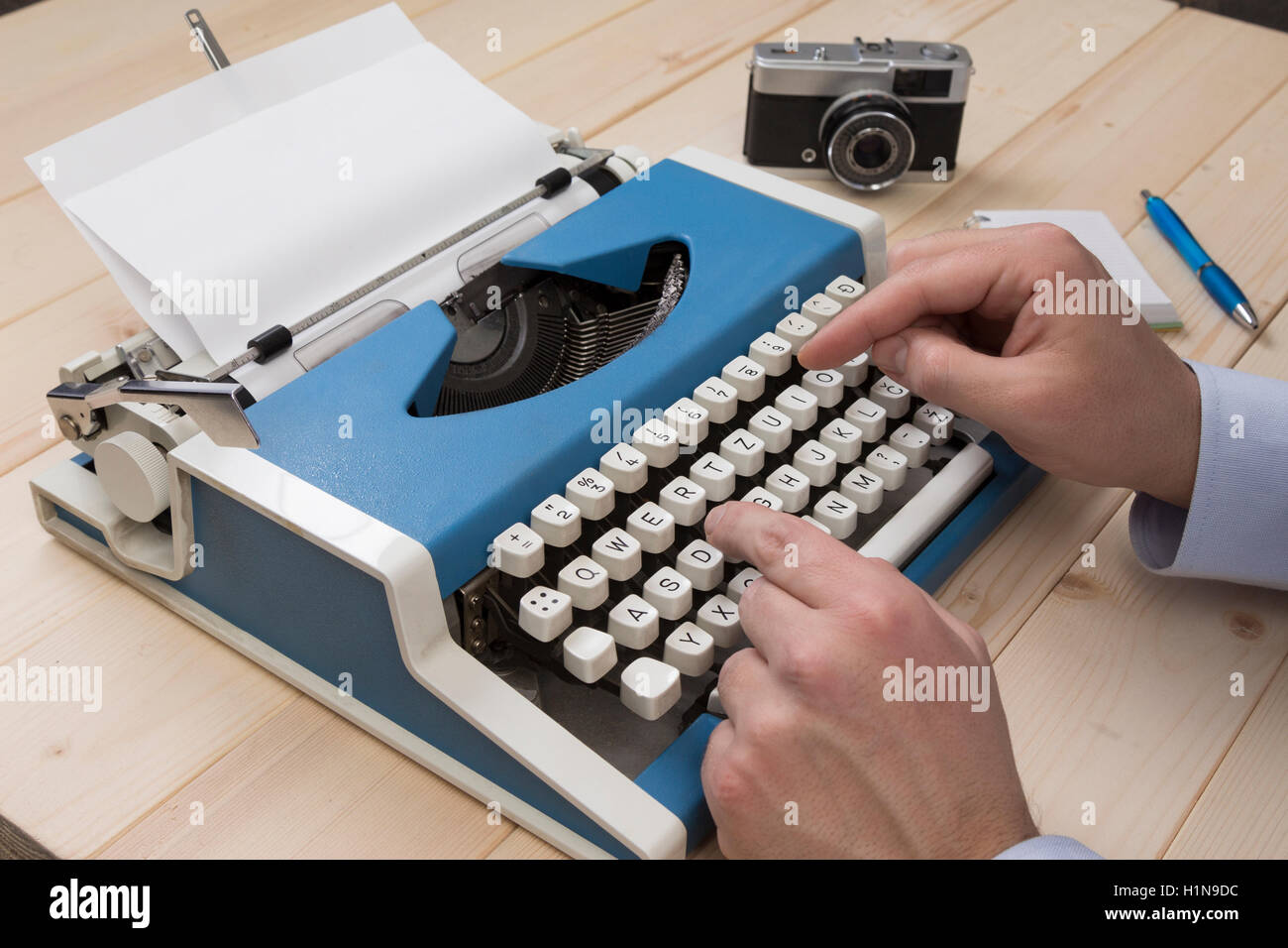 Journalist working on typewriter at his desk. No recognizable person ...