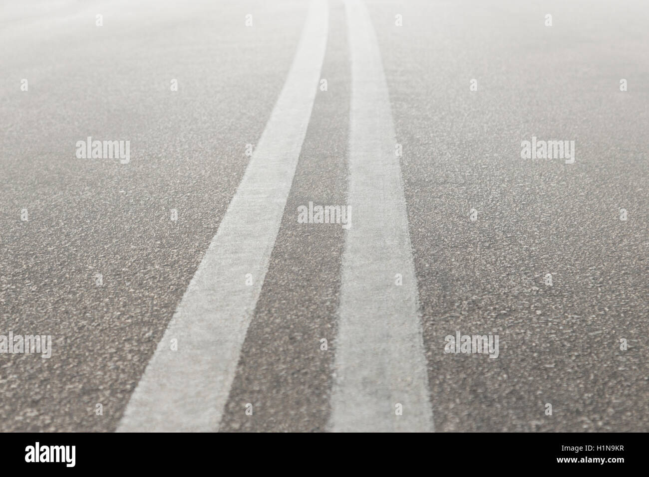 Asphalt road with white double solid line close up Stock Photo - Alamy