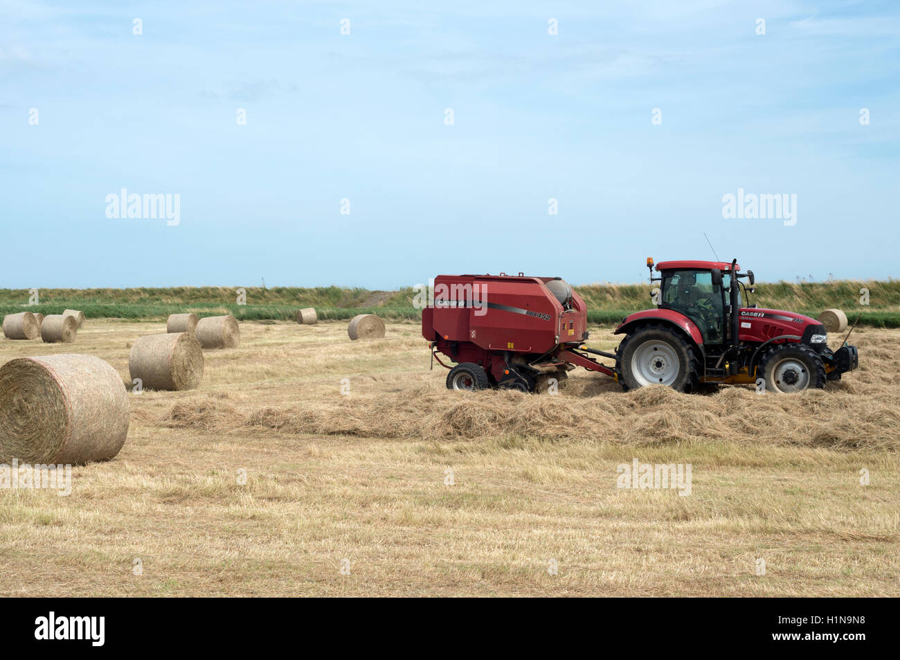 Hay being baled, Shingle Street, Suffolk, UK Stock Photo - Alamy