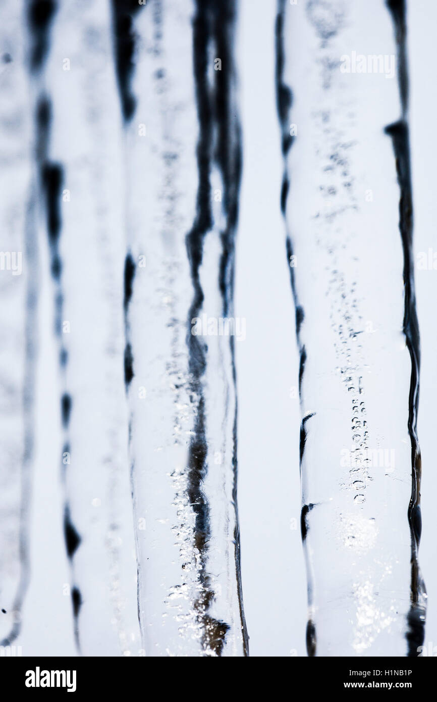 Abstract shapes, close up of large icicles hanging from a house in the ...