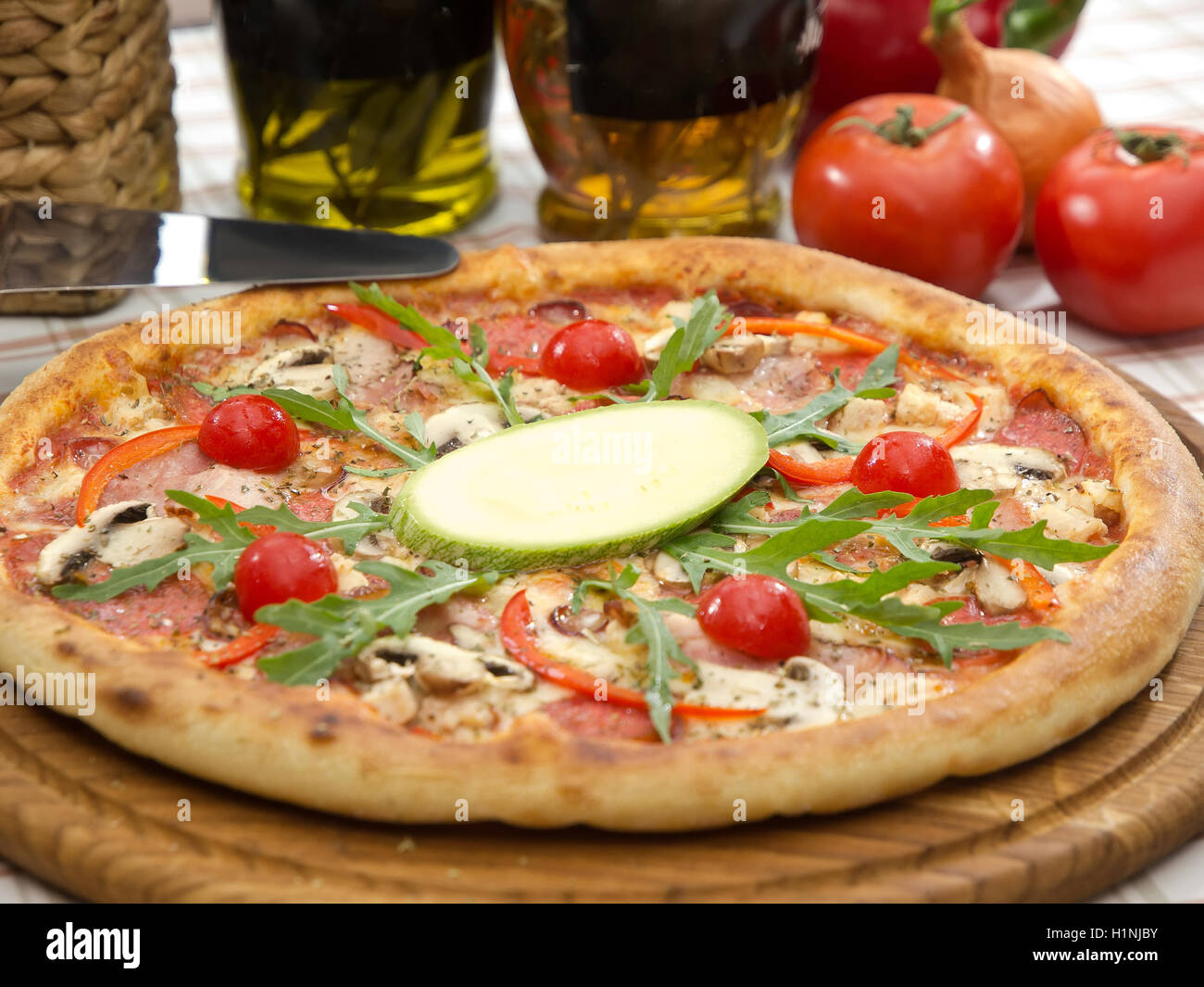whole Italian pizza on table with ingredients Stock Photo - Alamy