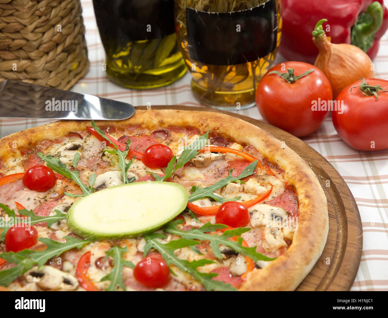 whole Italian pizza on table with ingredients Stock Photo - Alamy
