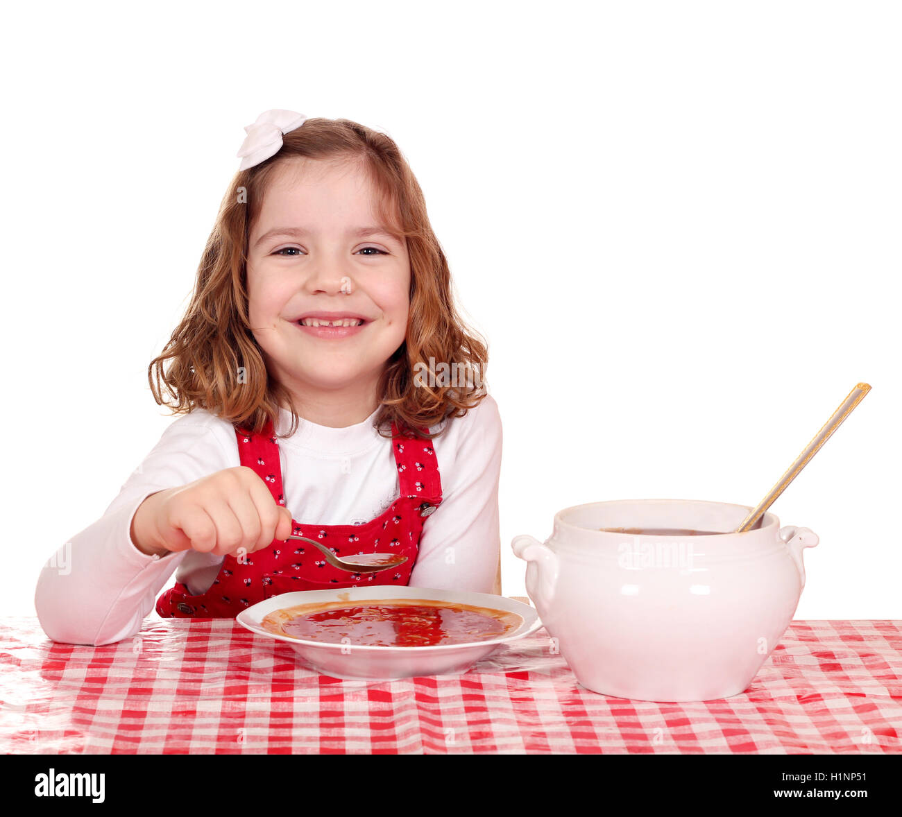 happy little girl eating red tomato soup Stock Photo - Alamy