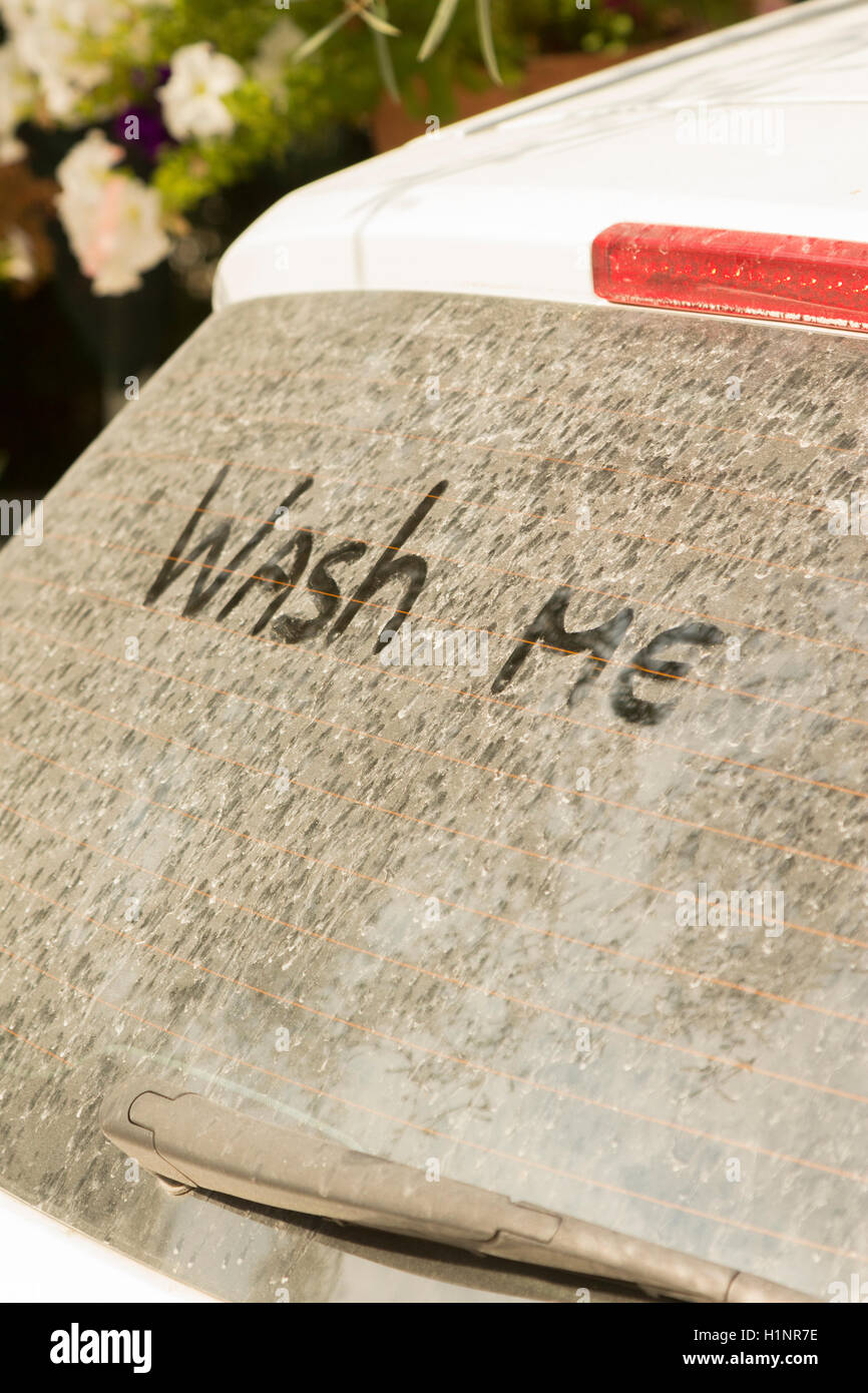 Wash me inscription on dirty car window Stock Photo - Alamy