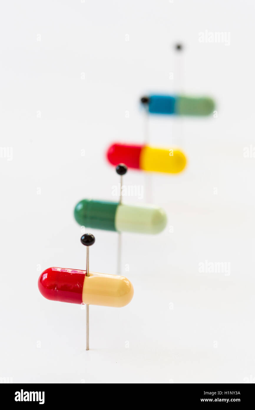Pins stuck into capsules Stock Photo - Alamy