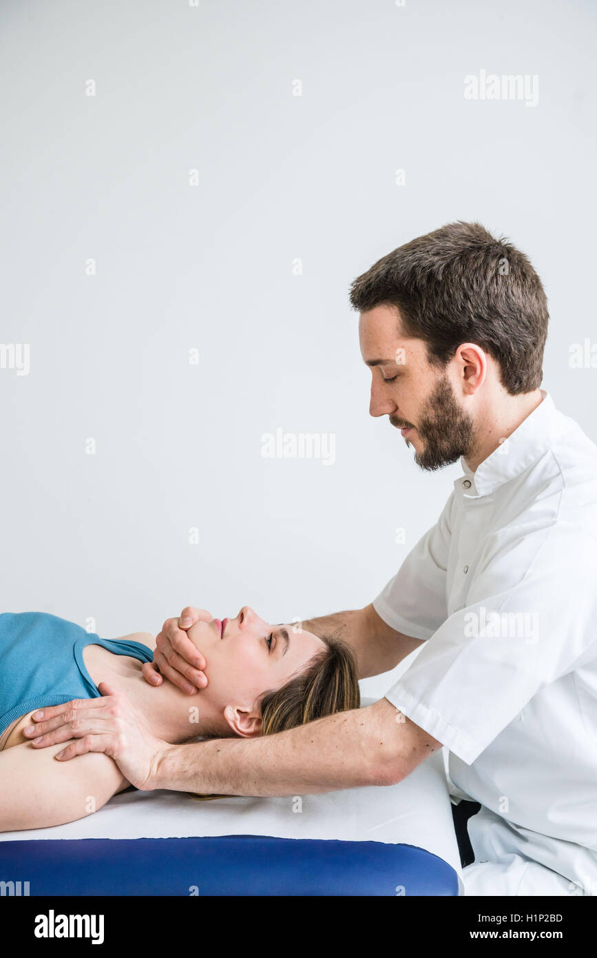Structural osteopathy session in a woman suffering from neck pain Stock ...