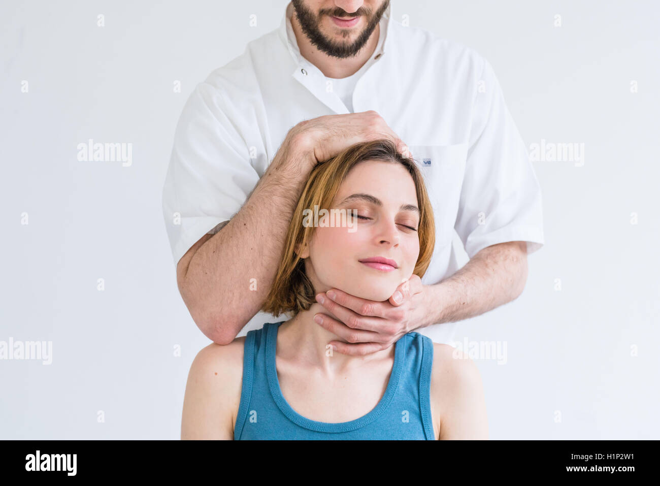Structural osteopathy session in a woman suffering from neck pain Stock ...