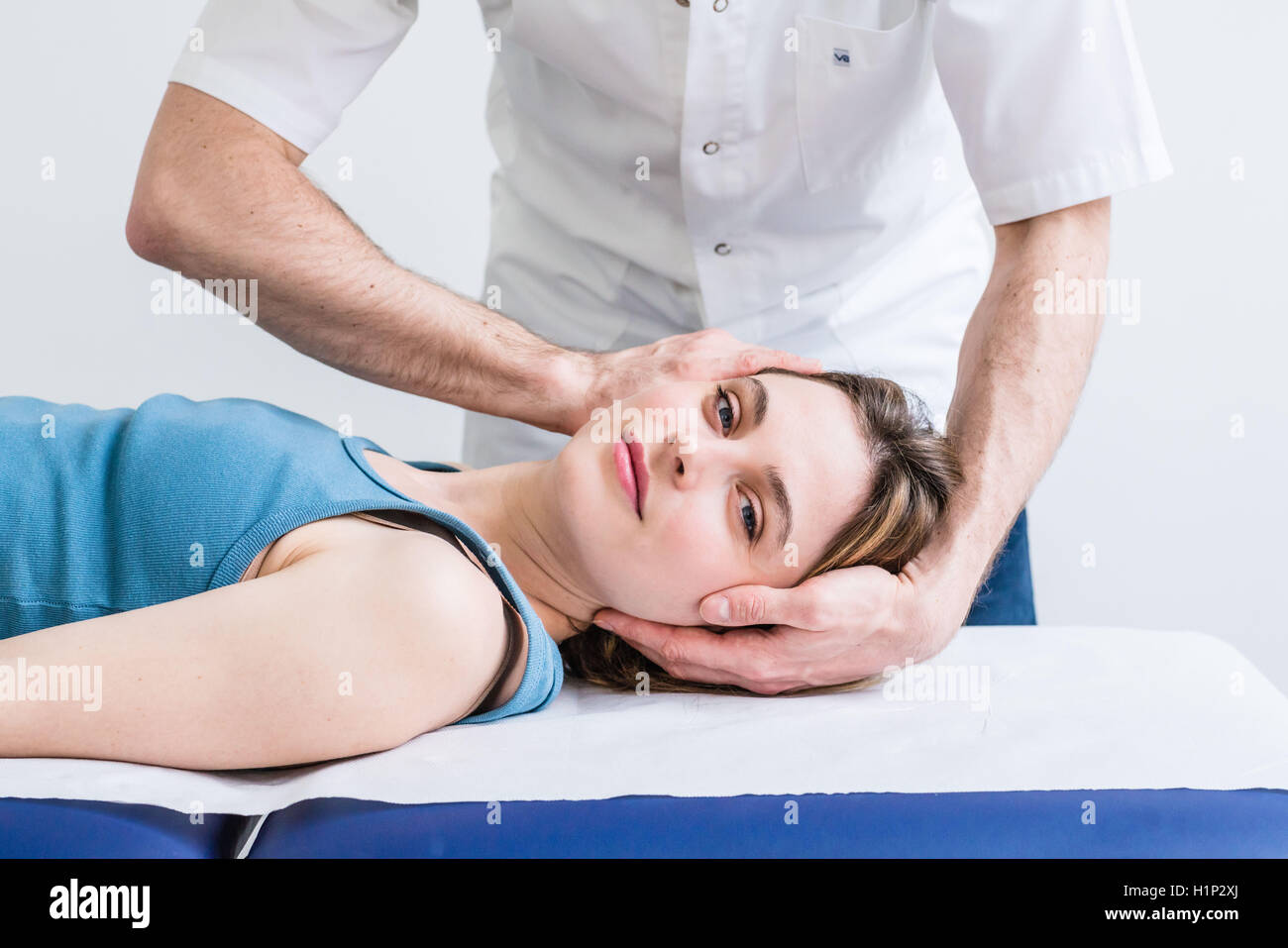 Structural osteopathy session in a woman suffering from neck pain Stock ...