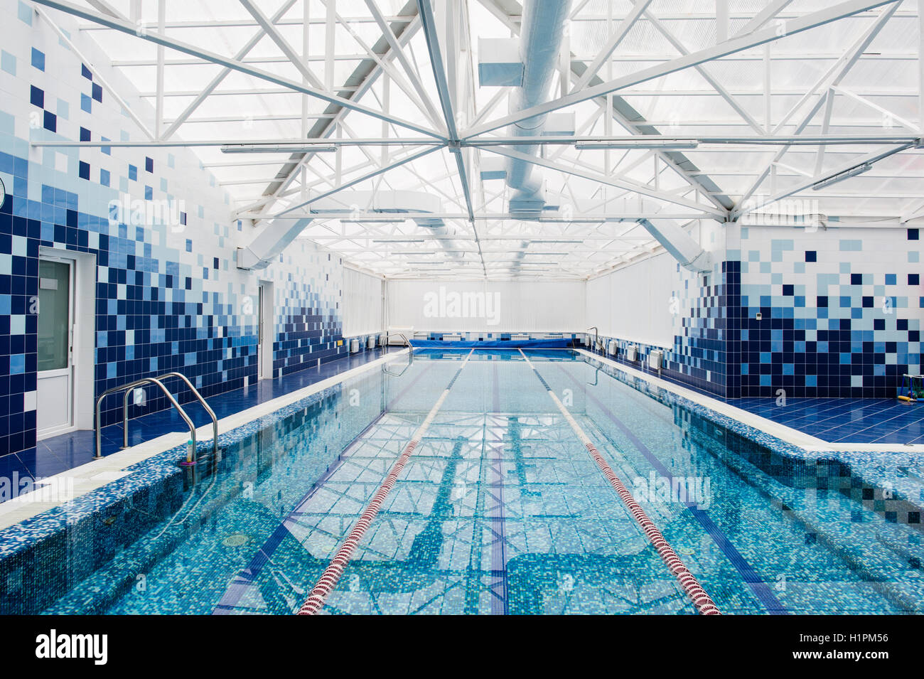 Modern indoor light swimming pool decorated with blue tiles Stock Photo ...
