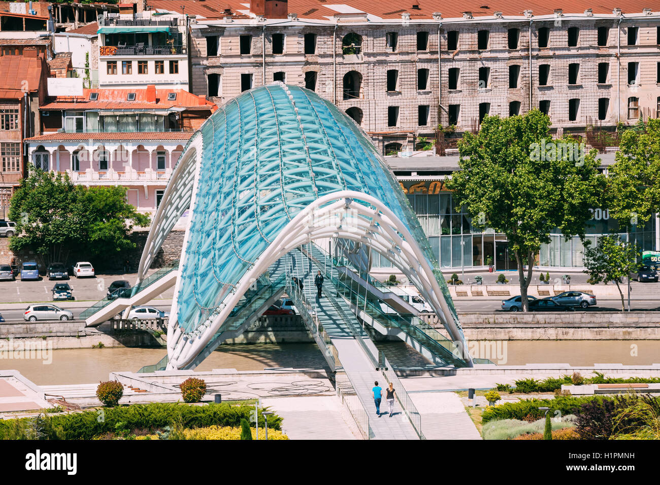 People Walking On The Bridge Of Peace Is A Bow-shaped Pedestrian Bridge ...