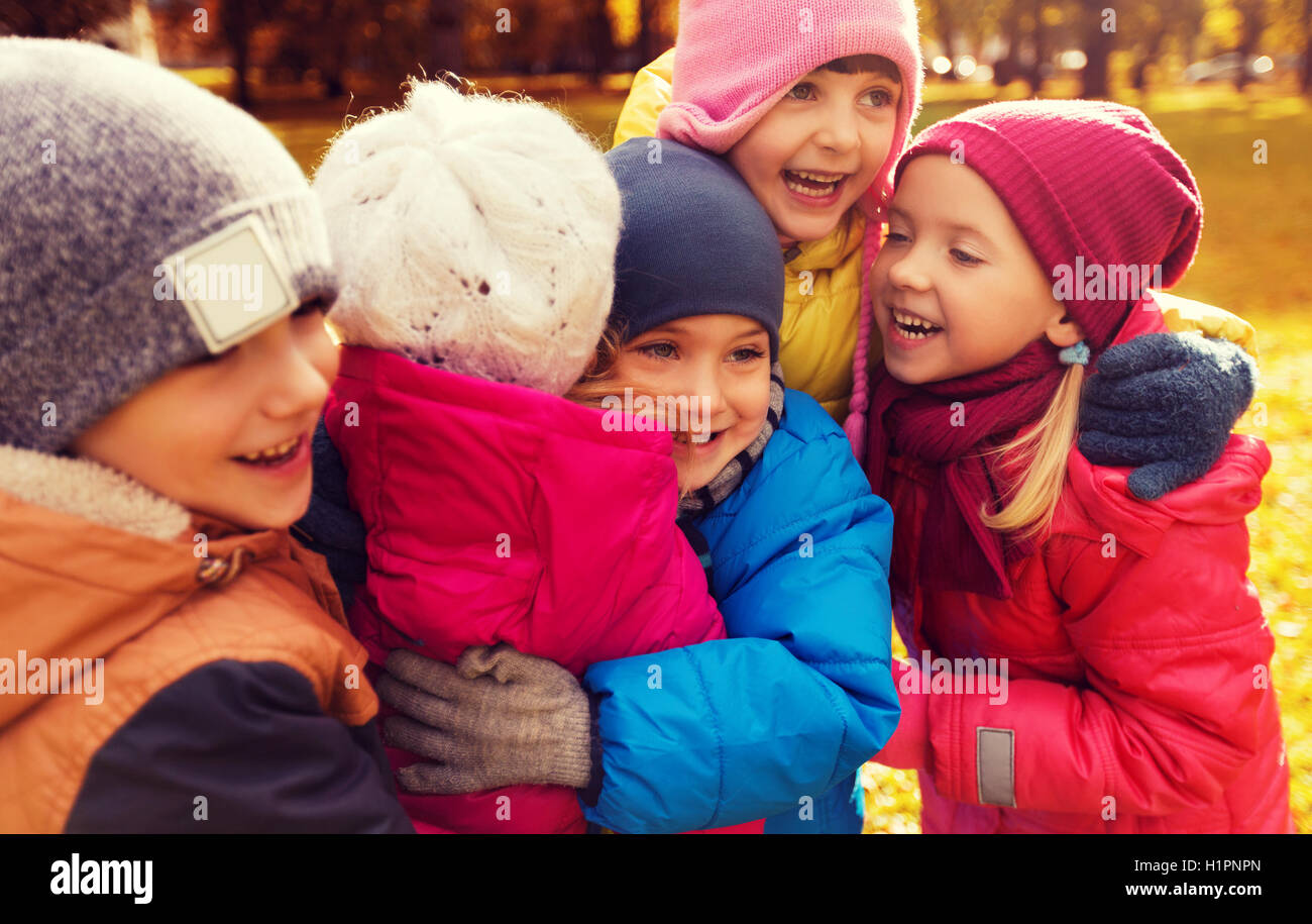 group of happy children hugging in autumn park Stock Photo - Alamy