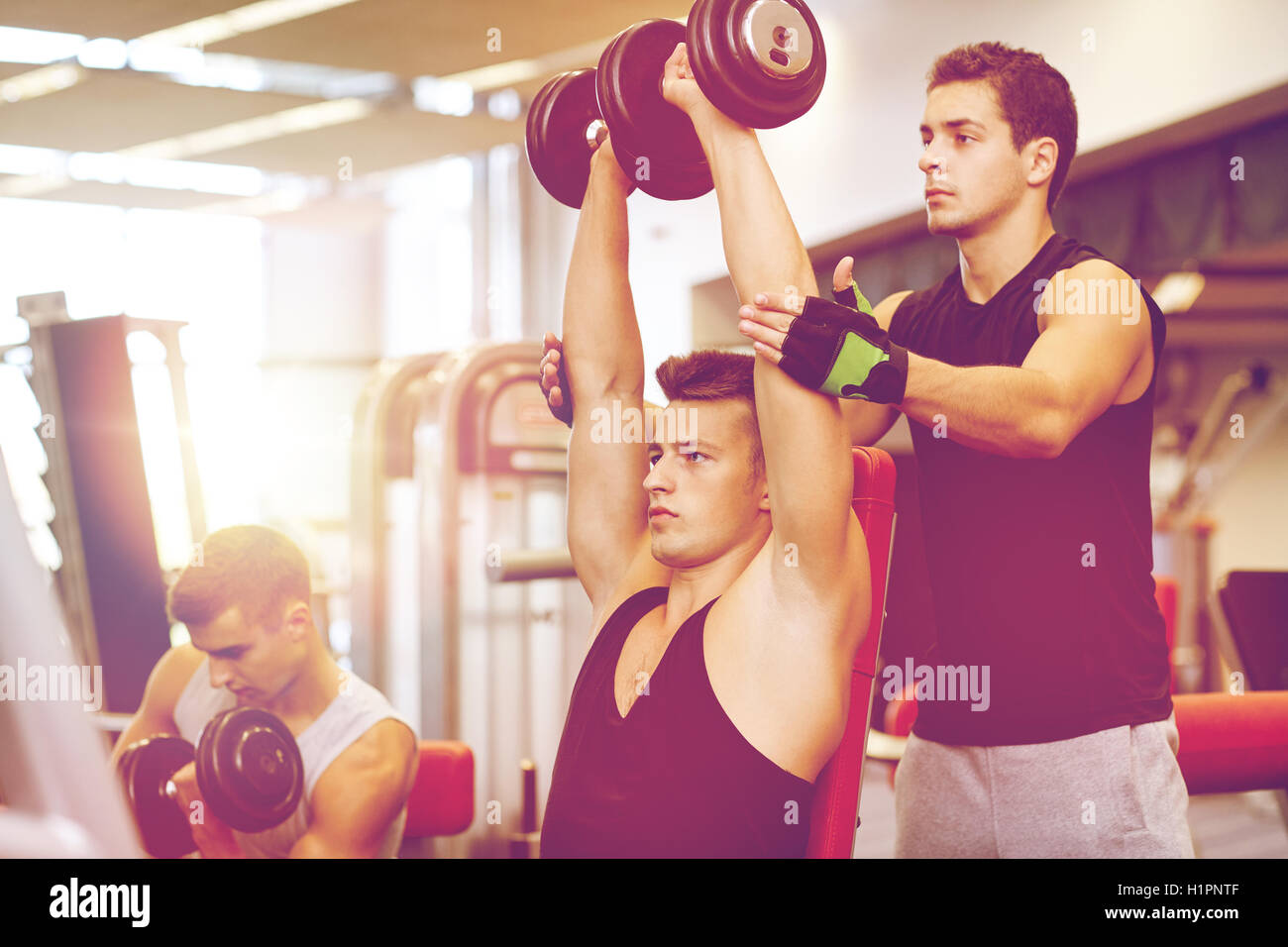 group of men with dumbbells in gym Stock Photo - Alamy