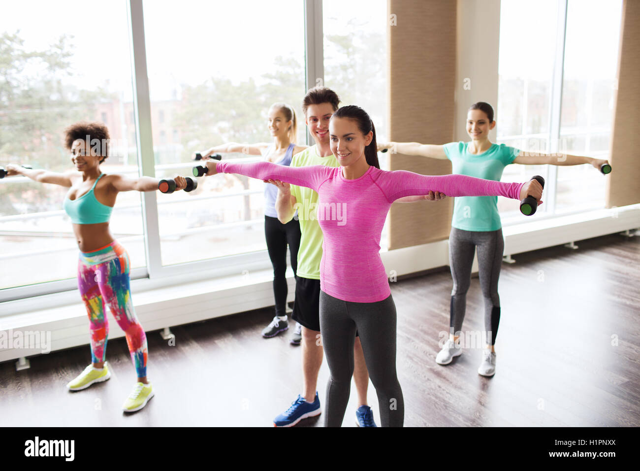 group of smiling people working out with dumbbells Stock Photo - Alamy