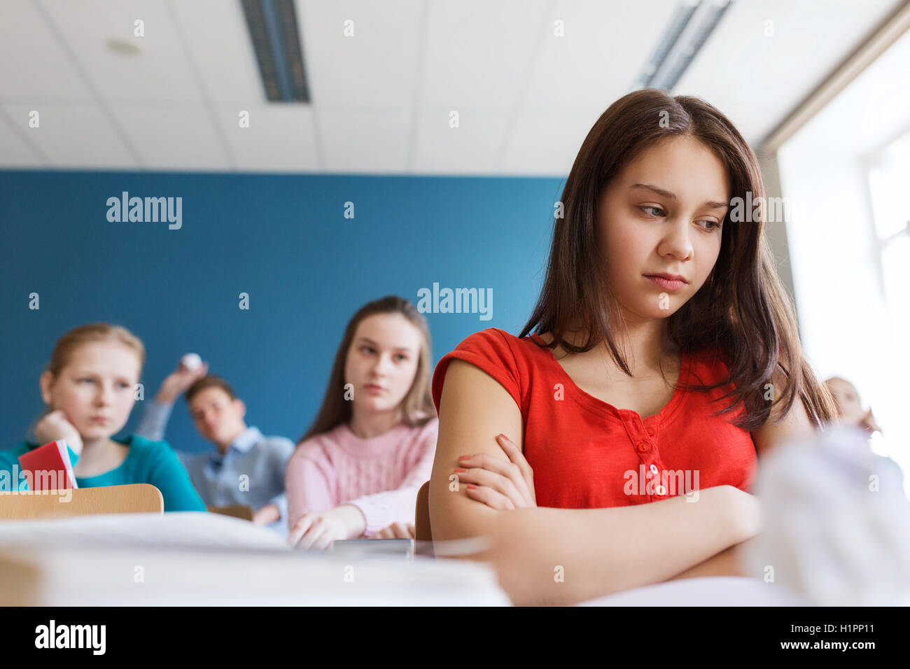 students gossiping behind classmate back at school Stock Photo - Alamy