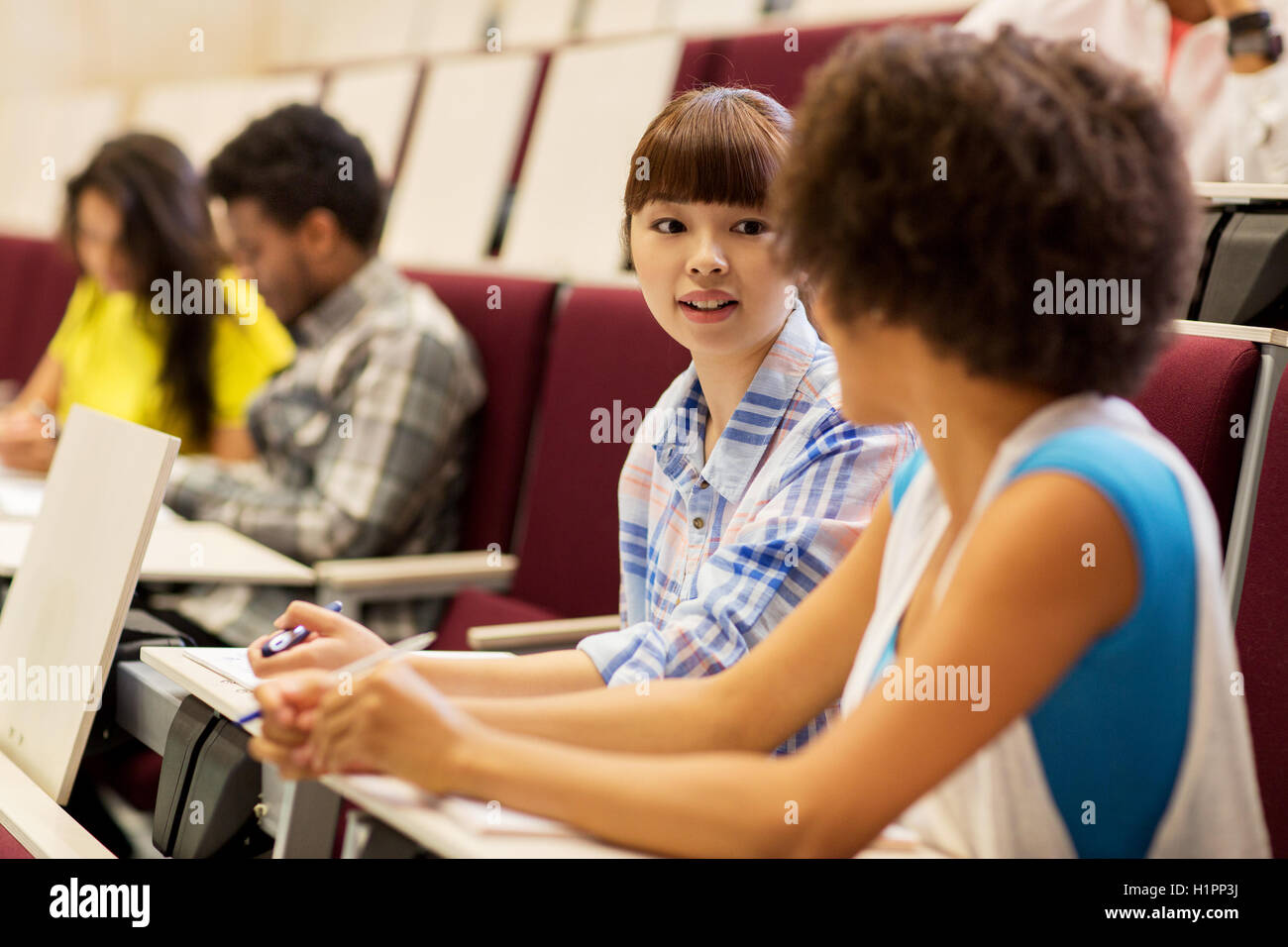 group of students talking in lecture hall Stock Photo - Alamy