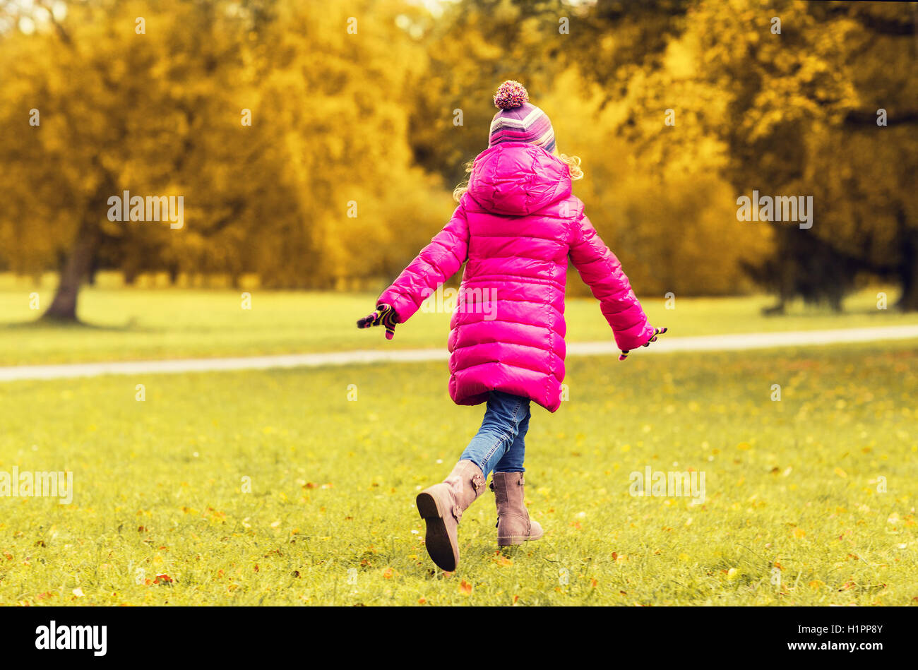 happy little girl running in autumn park Stock Photo - Alamy