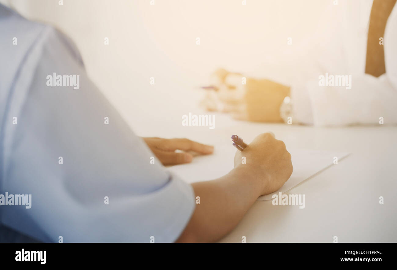 close up of doctor taking notes at hospital Stock Photo - Alamy