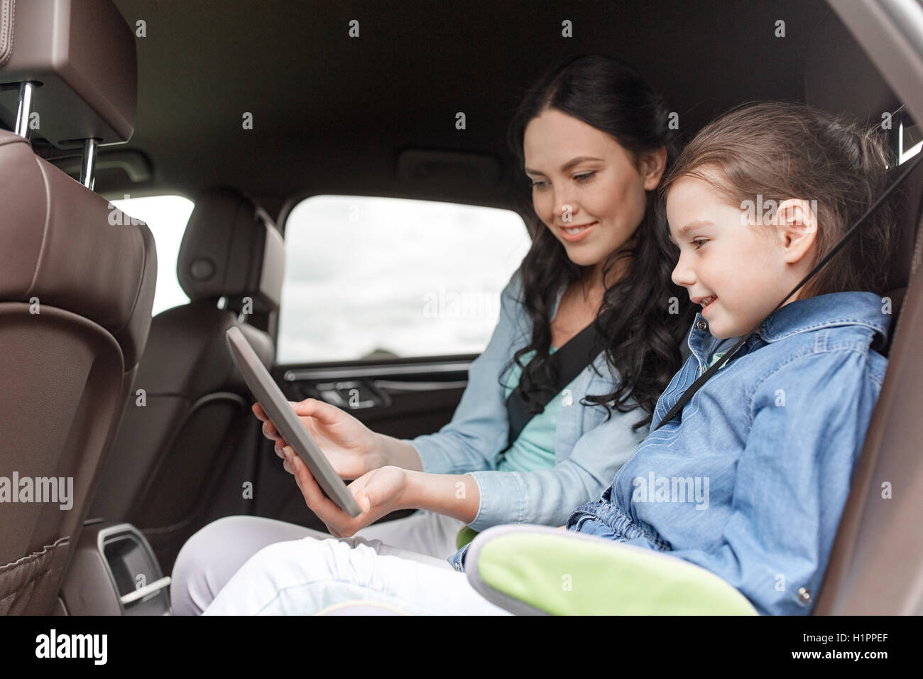 happy family with tablet pc driving in car Stock Photo - Alamy