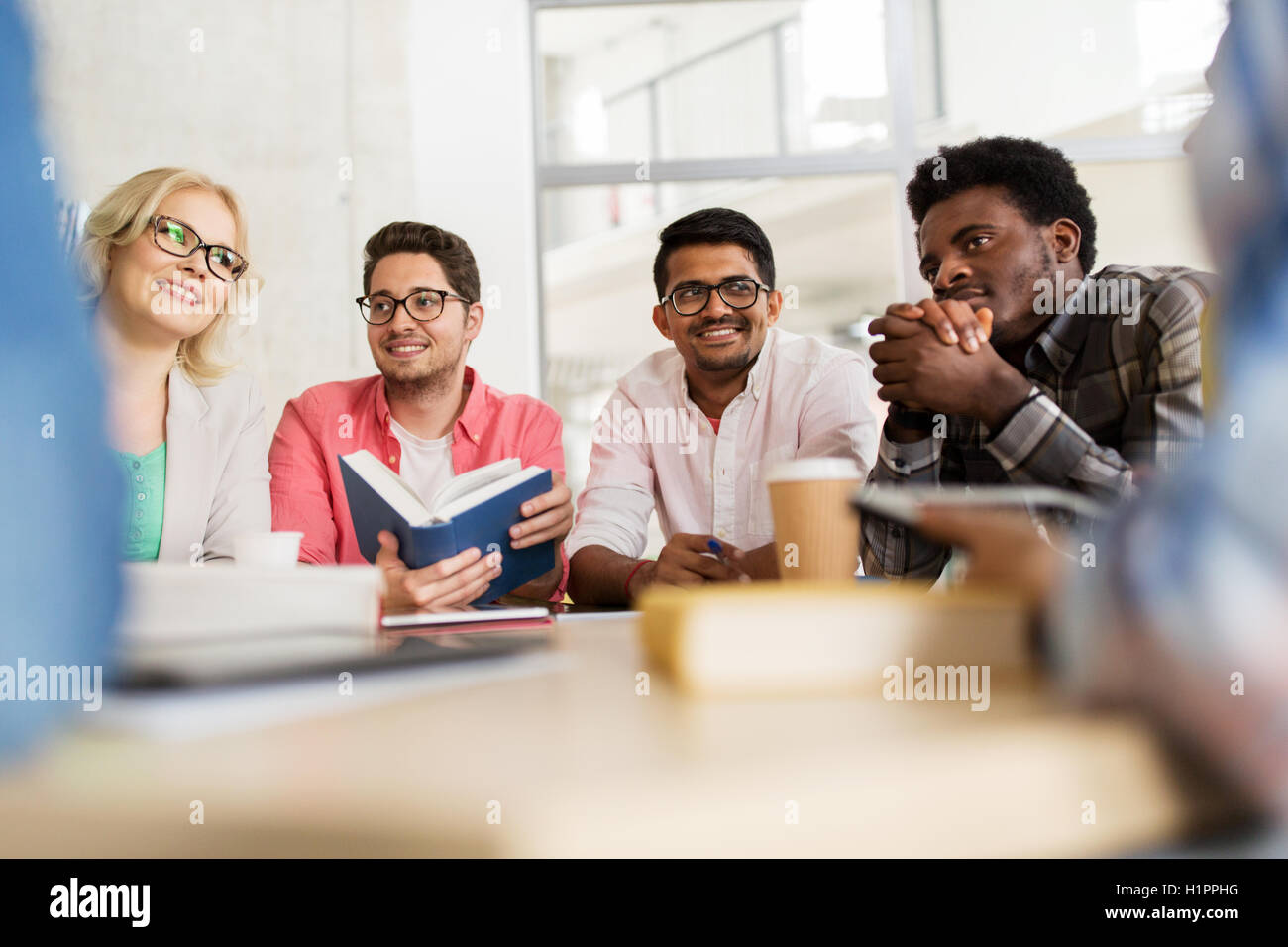 group of high school students sitting at table Stock Photo - Alamy