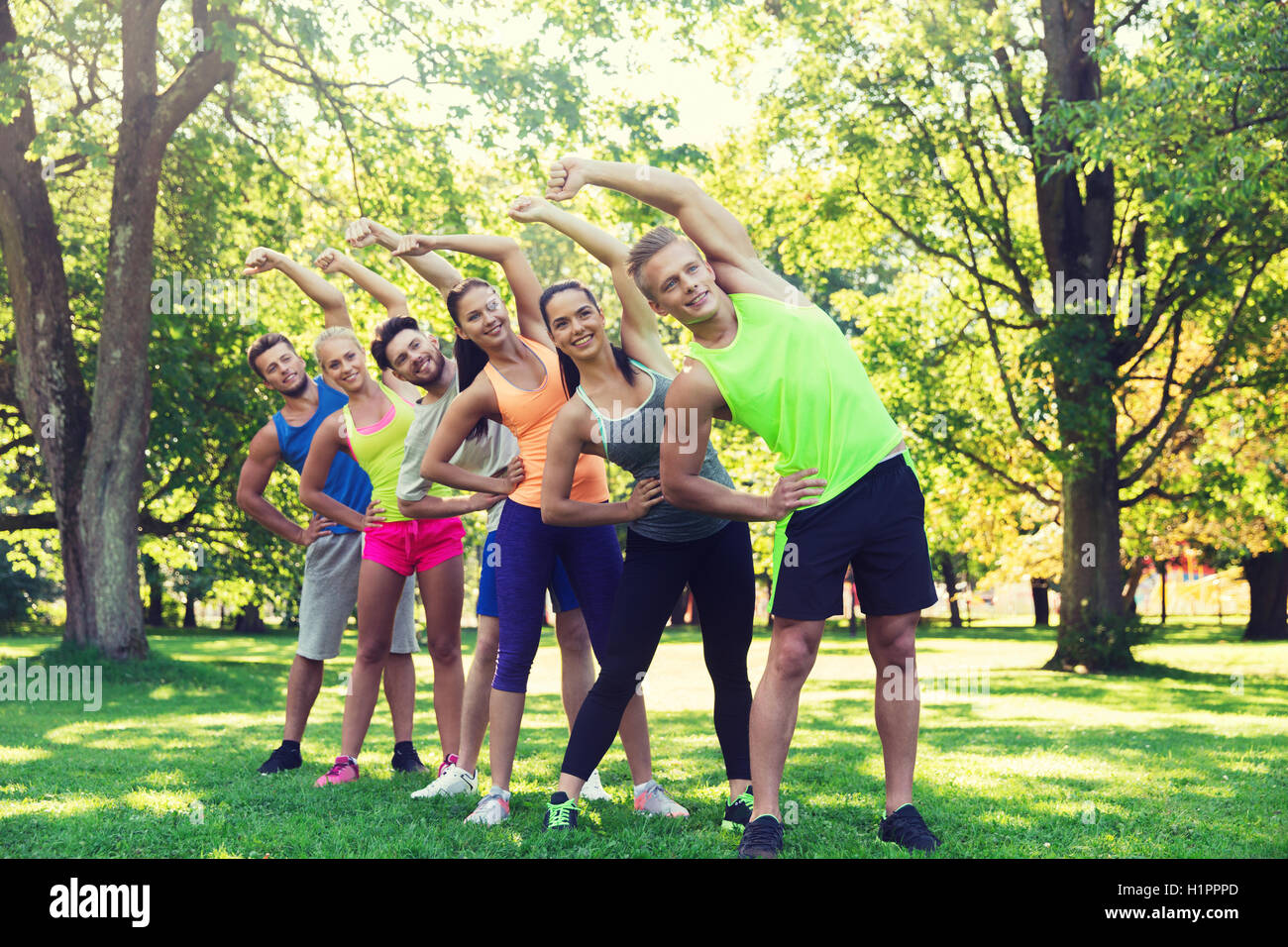 group of friends or sportsmen exercising outdoors Stock Photo - Alamy