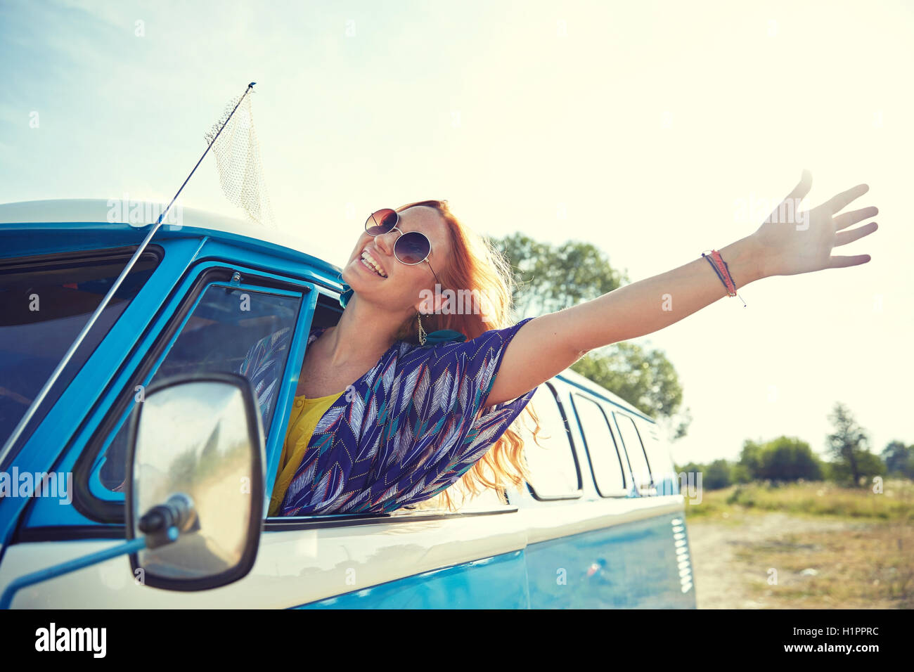 smiling young hippie woman driving minivan car Stock Photo - Alamy