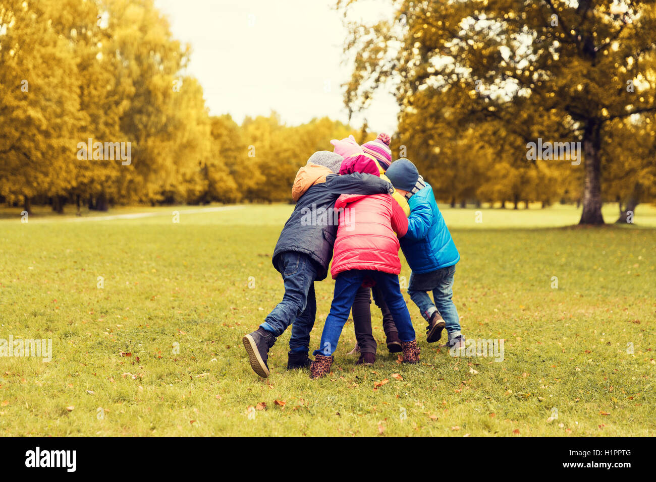 group of happy children hugging in autumn park Stock Photo - Alamy