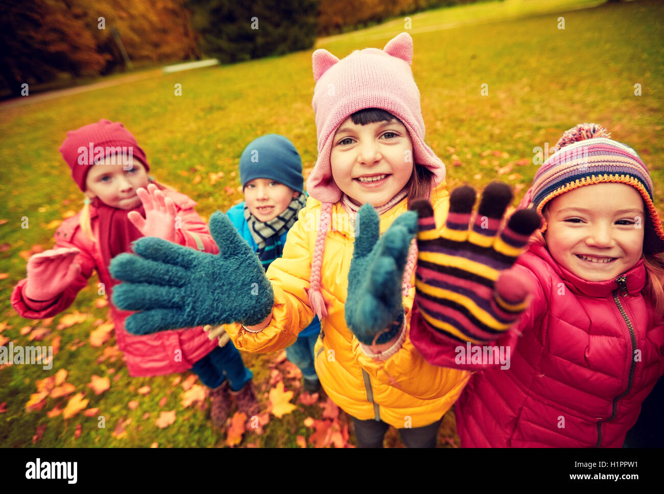 happy children waving hands in autumn park Stock Photo - Alamy