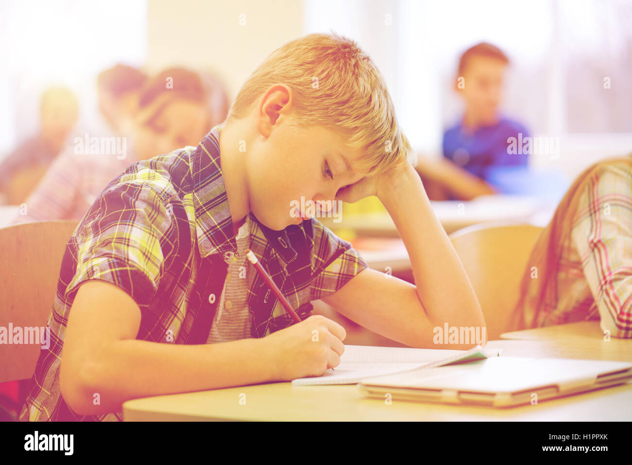 group of school kids writing test in classroom Stock Photo - Alamy