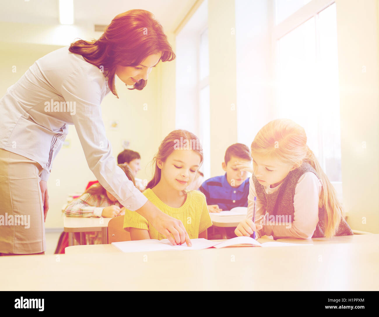 group of school kids writing test in classroom Stock Photo - Alamy