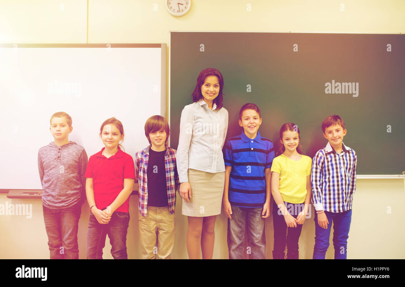 group of school kids and teacher in classroom Stock Photo - Alamy